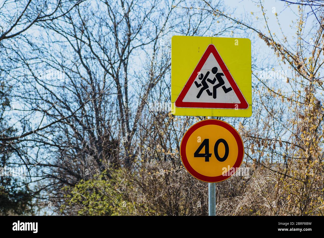 Road sign Caution children and speed limit 40 on the background of ...