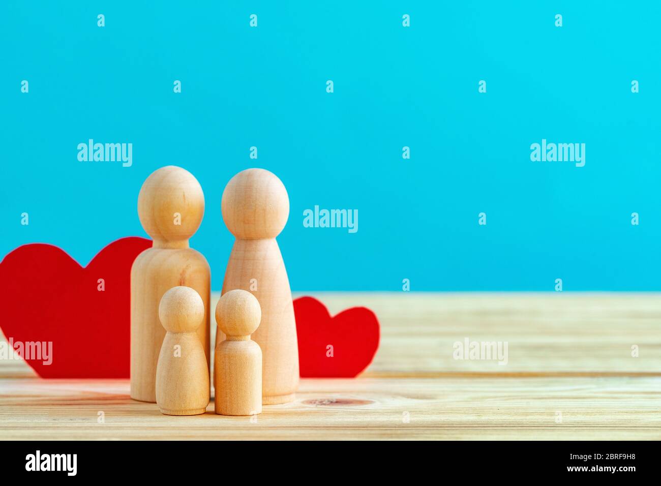 Wooden little figures of people. Family concept Stock Photo - Alamy