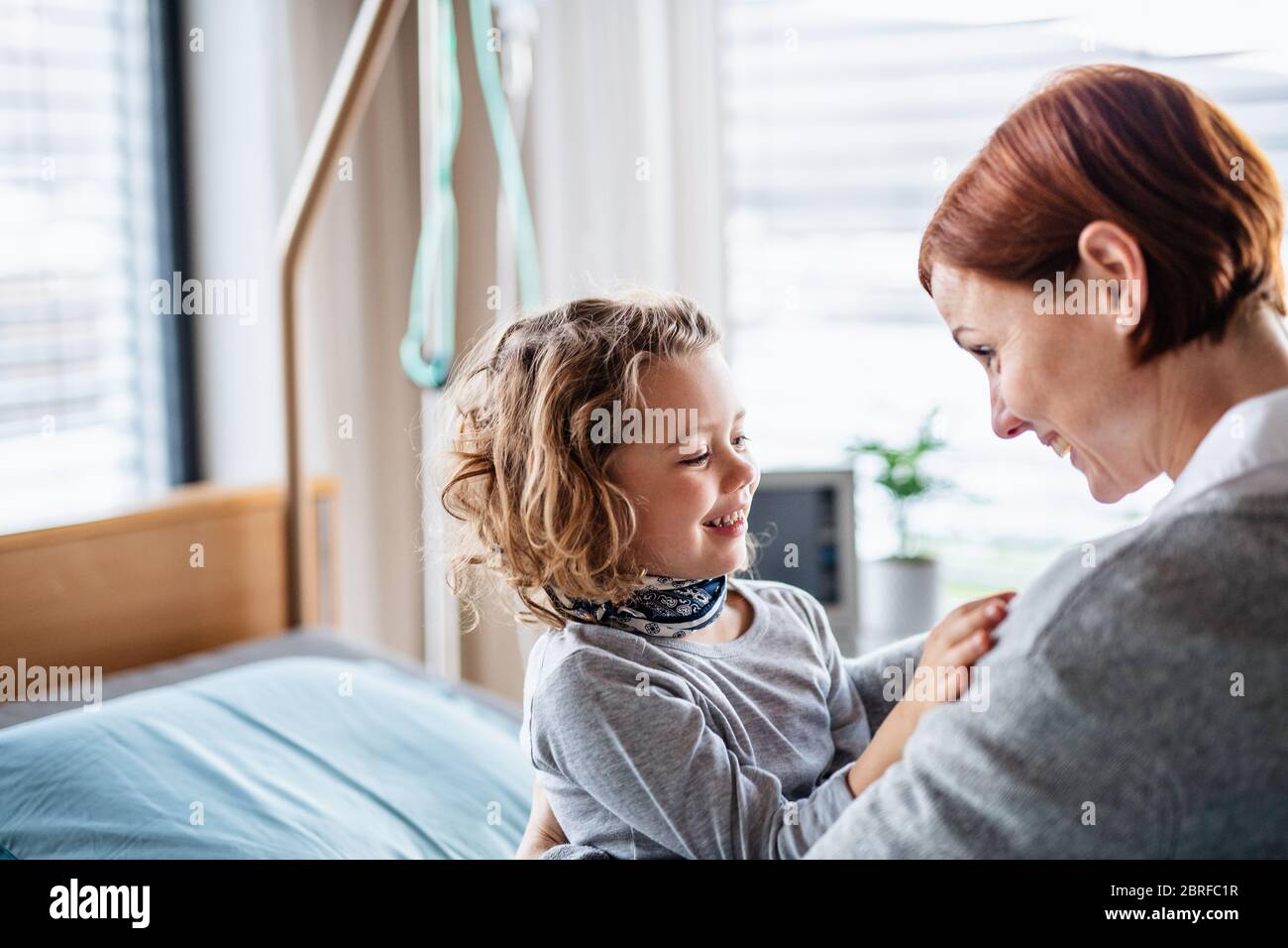 Caring Mother Visiting Small Girl Daughter In Bed In Hospital Stock