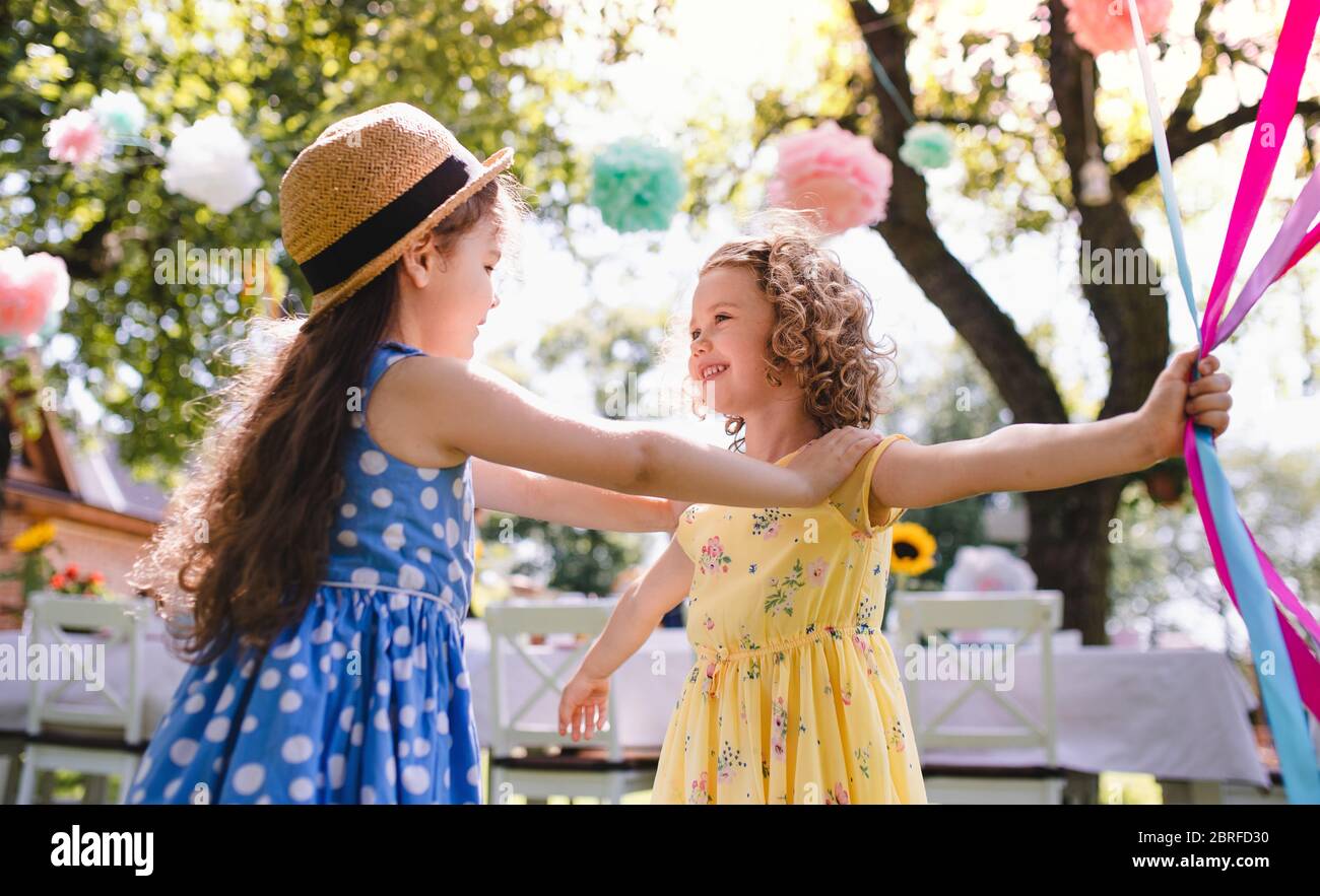 Small children outdoors in garden in summer, playing Stock Photo - Alamy