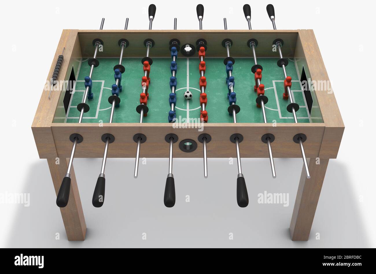 A full view of a wooden foosball table with teams in red and blue on an ...