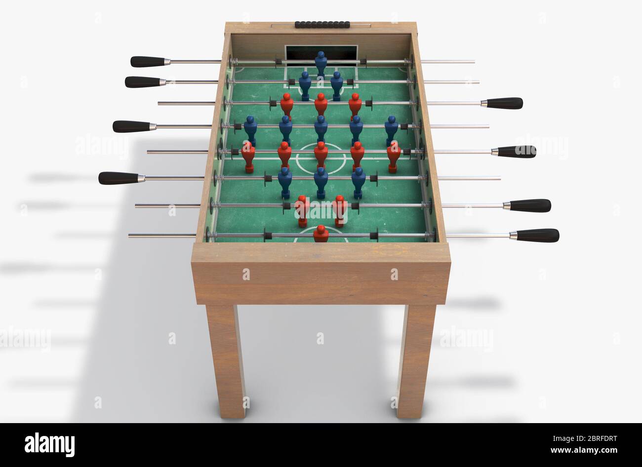 A full view of a wooden foosball table with teams in red and blue on an ...