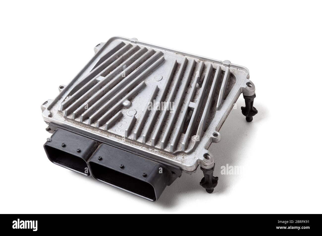 A plastic car engine control unit with metal elements on a white ...