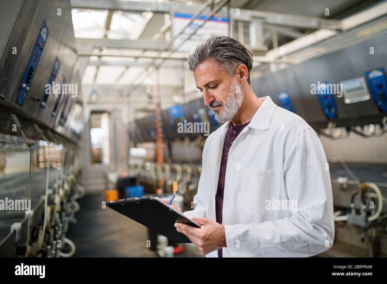 Man manager working on diary farm, agriculture industry Stock Photo - Alamy
