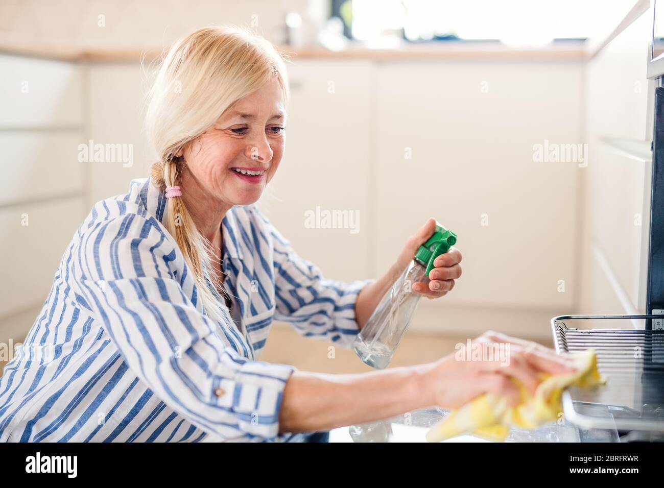 Old woman cleaning hi-res stock photography and images - Alamy