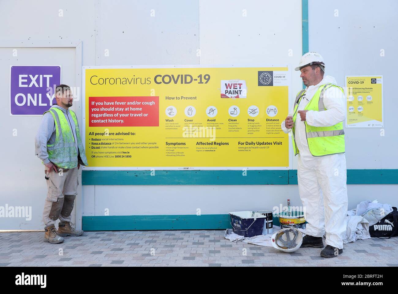 Construction workers practice social distancing at a construction site ...