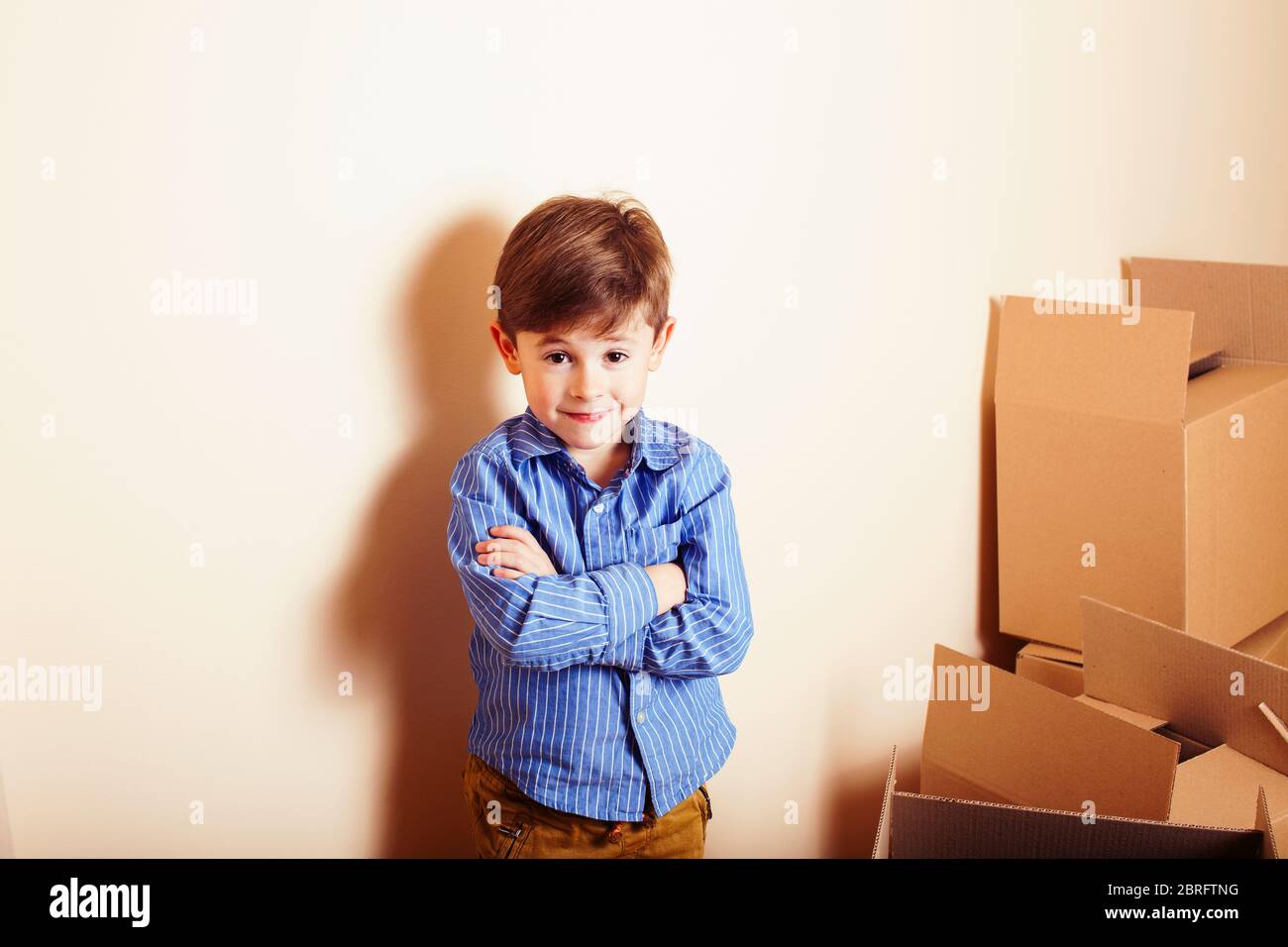 little cute boy in empty room, move to new house. home alone among ...