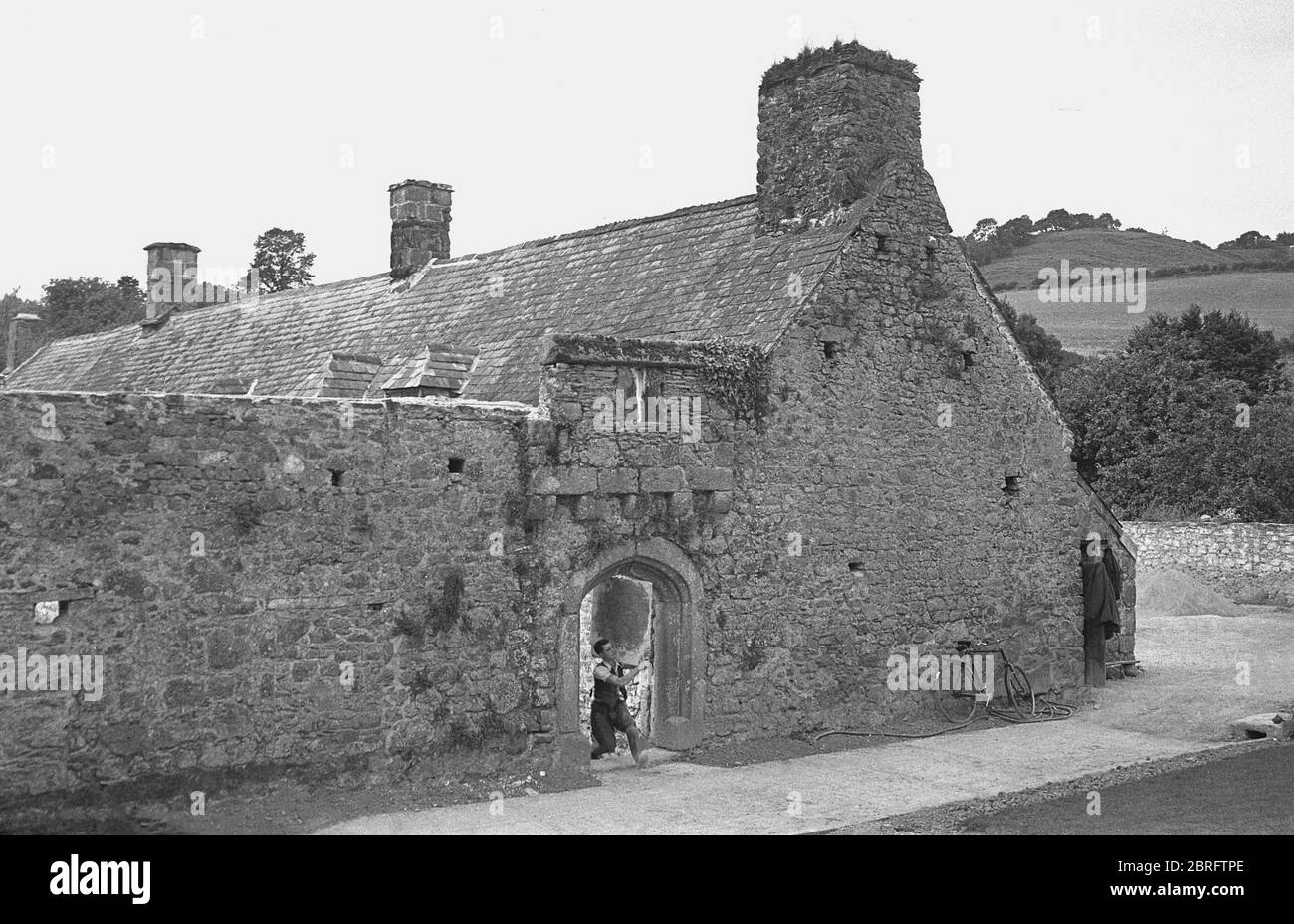 1930s, historical, a workman coming out of the entrance to an enclosed ...