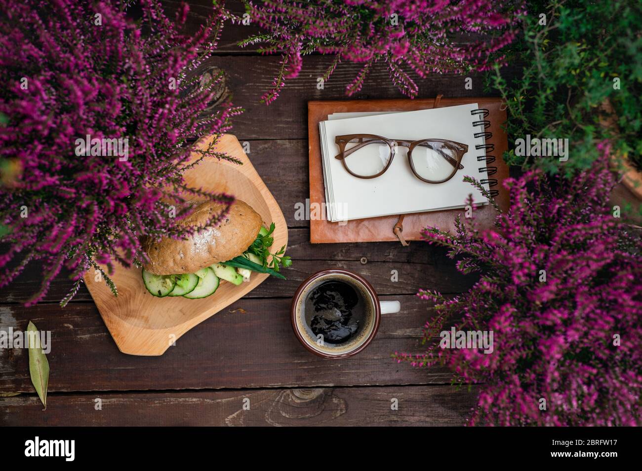 Composition of coffee and light lunch on bench outdoors on terrace ...
