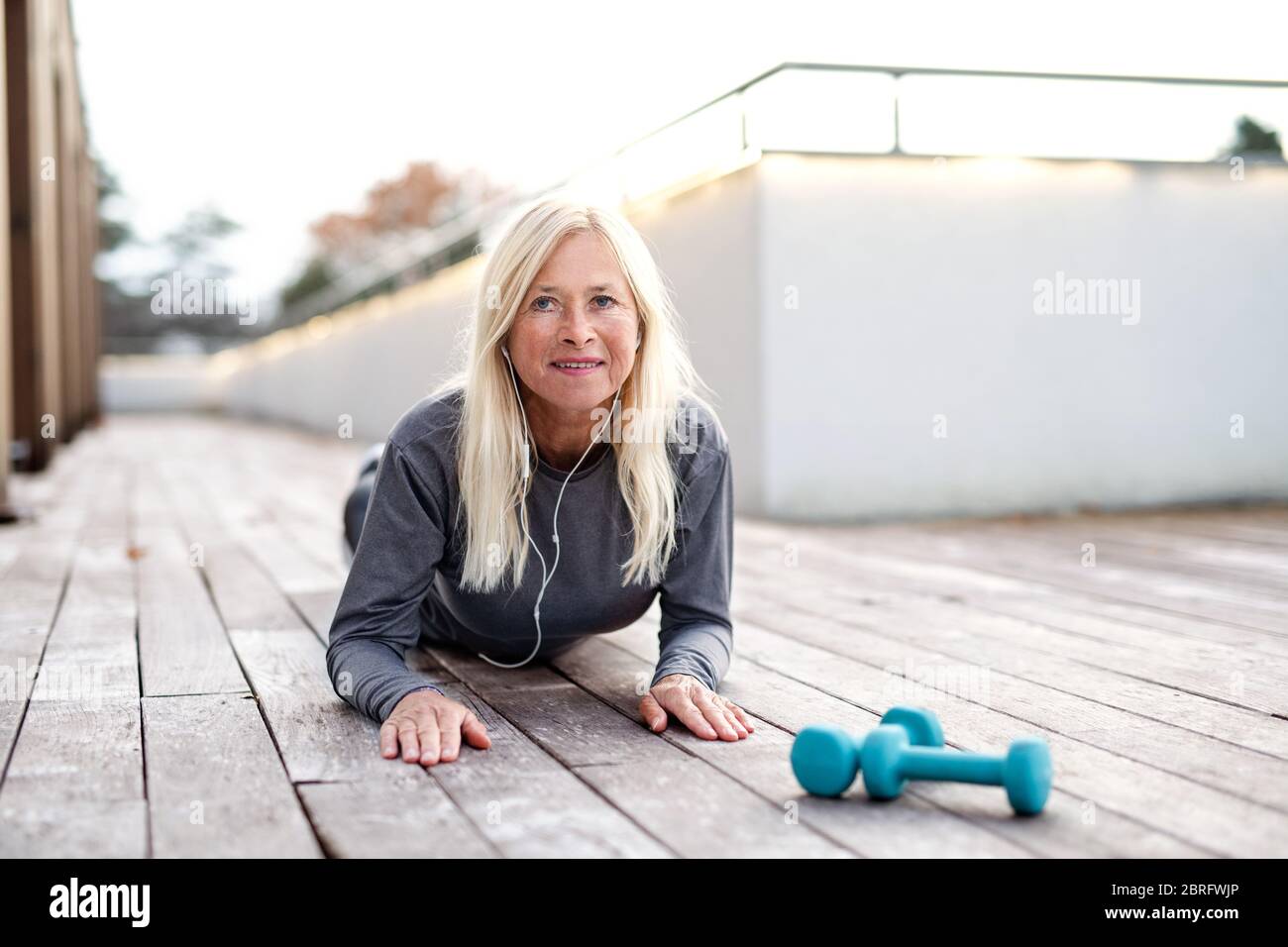 A senior woman doing exercise outdoors, stretching Stock Photo - Alamy
