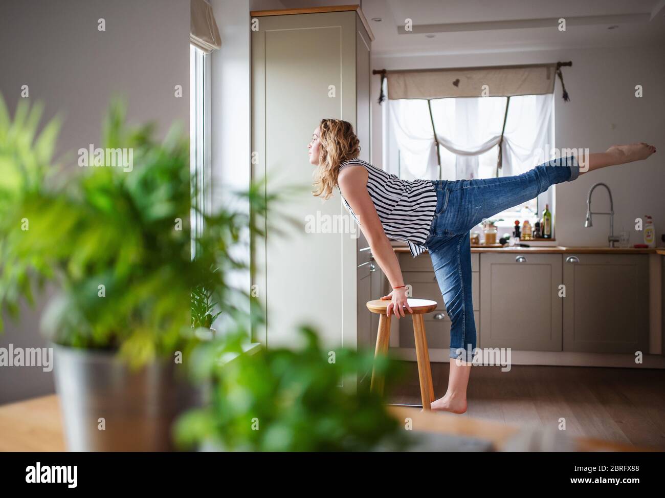 Young woman relaxing indoors at home, stretching Stock Photo - Alamy