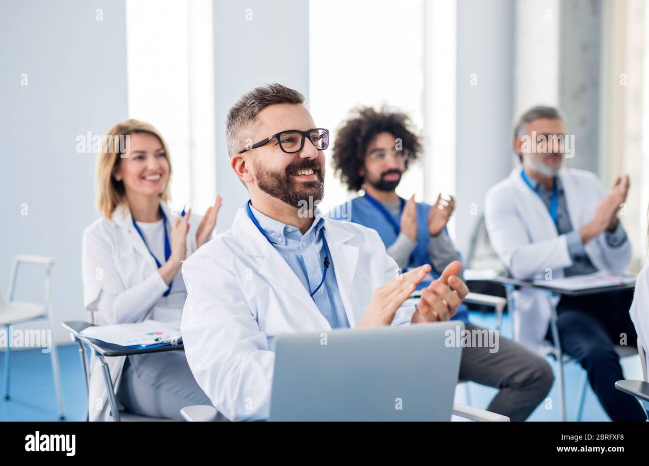 Group of doctors listening to presentation on medical conference Stock ...