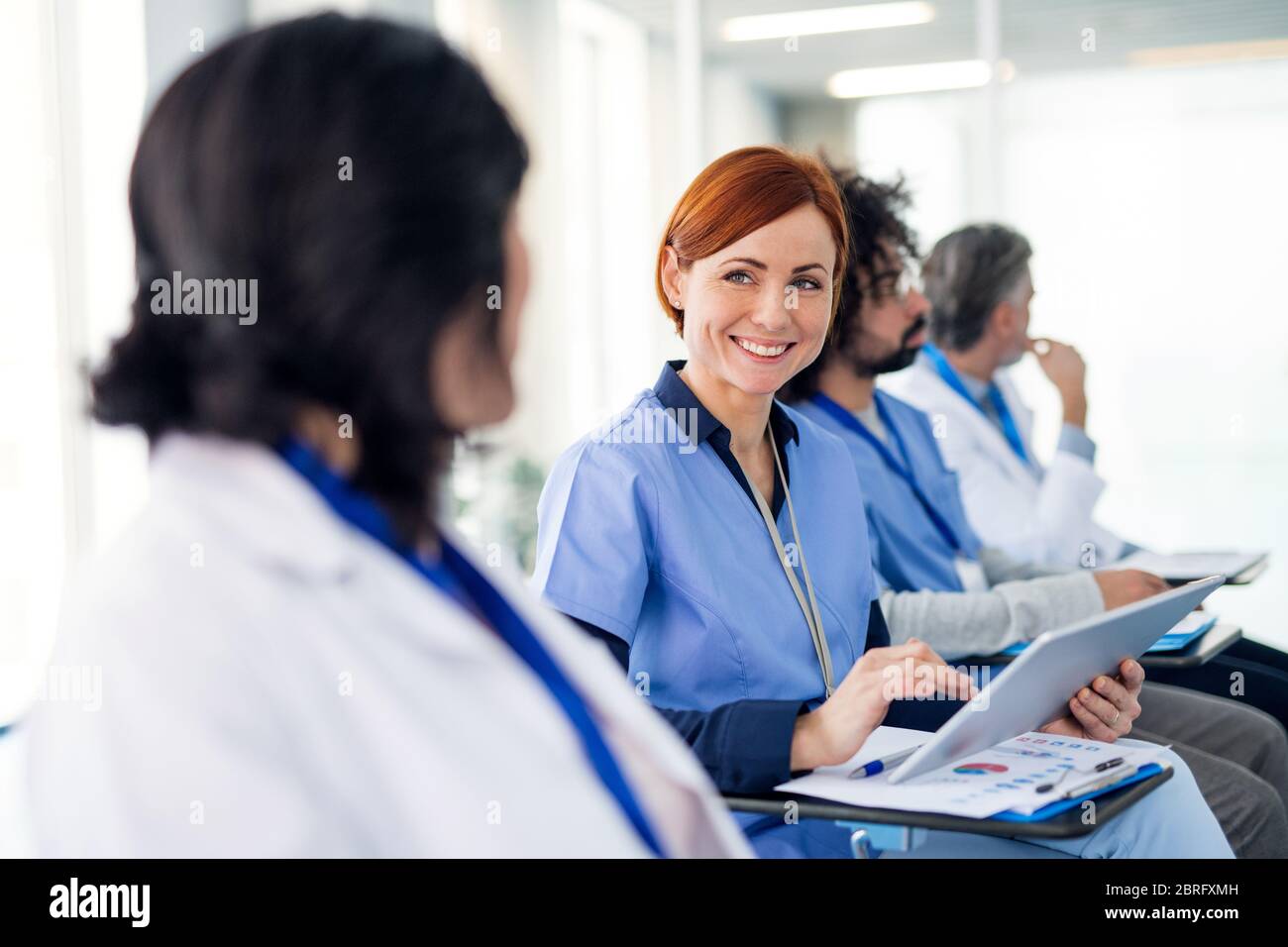 Group of doctors with tablet on medical conference, talking Stock Photo ...