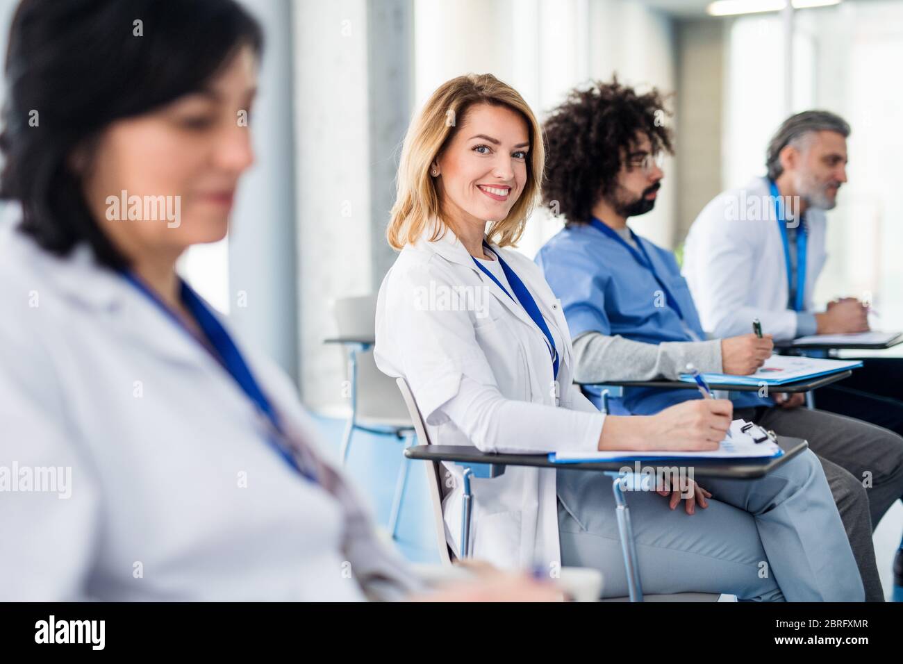 Group of doctors listening to presentation on medical conference Stock ...