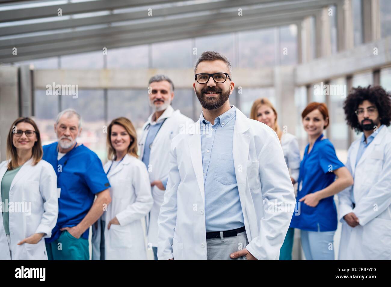Group of doctors standing in corridor on medical conference Stock Photo ...