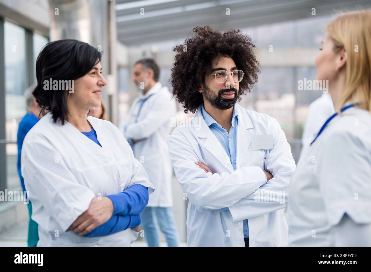 Group of doctors standing in corridor on medical conference Stock Photo ...