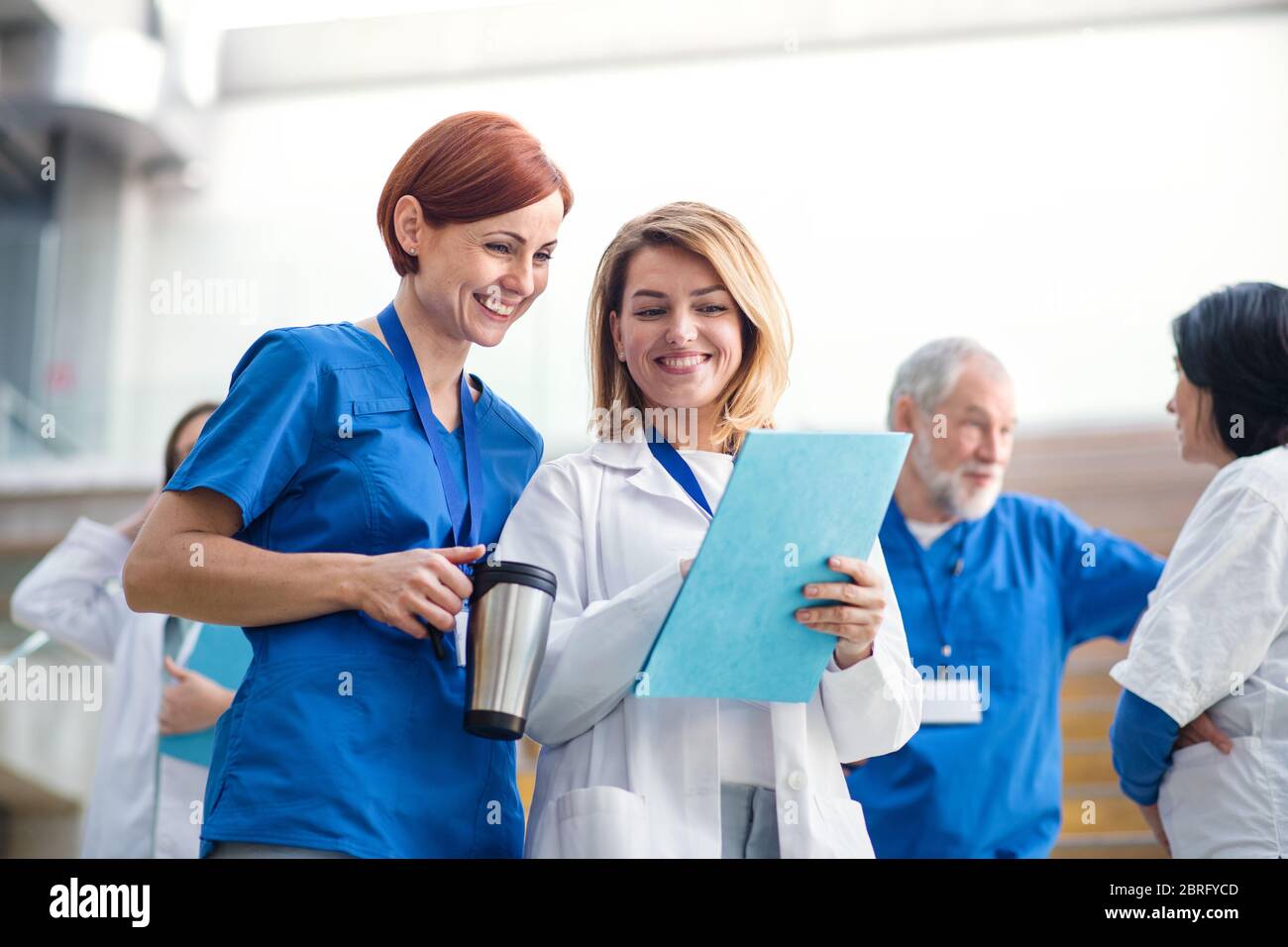 Group of doctors standing on medical conference, talking Stock Photo ...