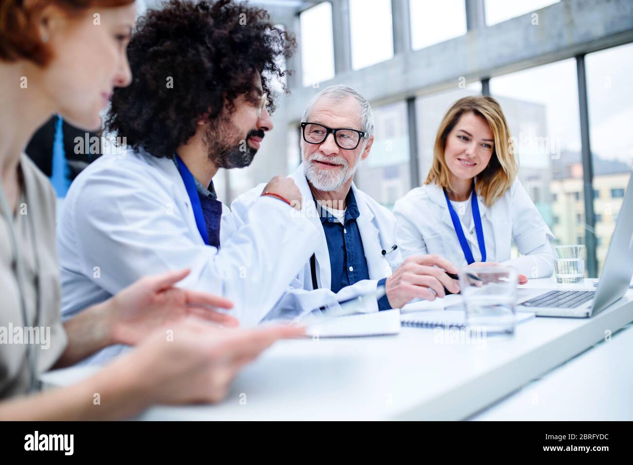 Group of doctors on medical conference, talking Stock Photo - Alamy