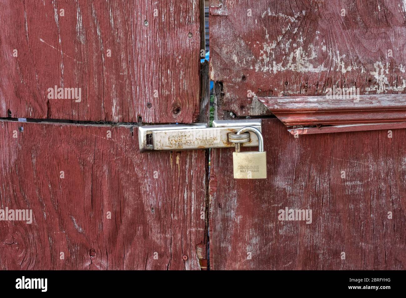 Old wooden gate closed with padlock Stock Photo - Alamy