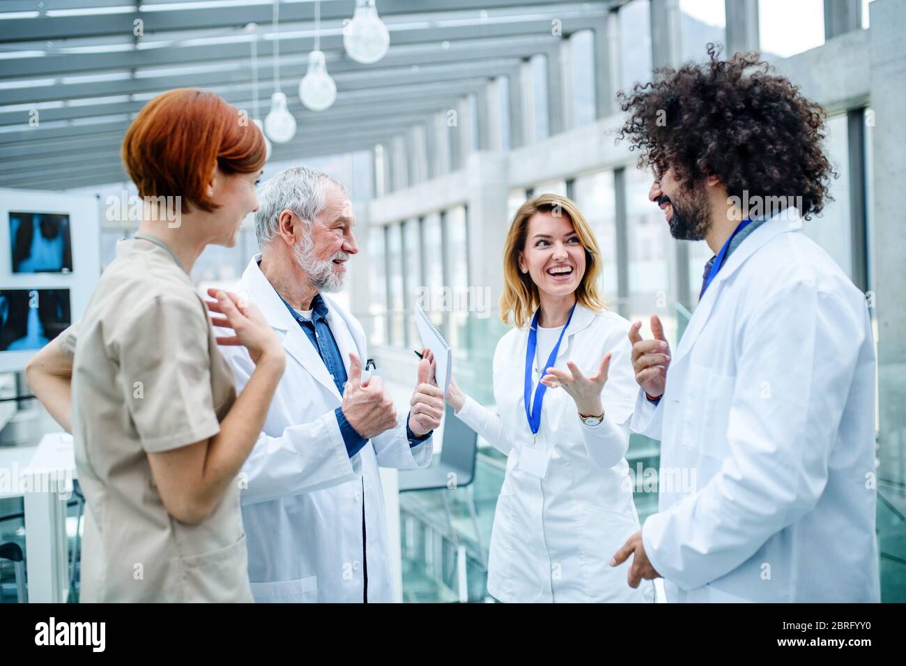 Group of doctors standing on conference, medical team laughing Stock ...