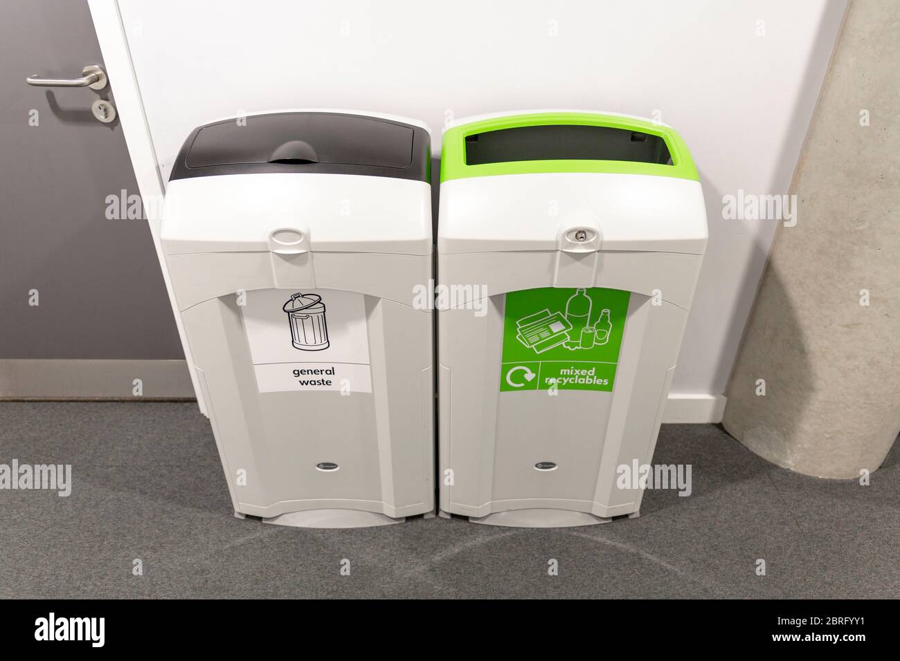 Different colored indoor bins for collection of recycle materials in a ...