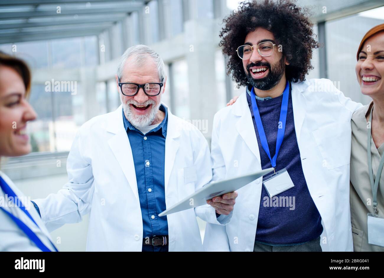 Group of doctors with tablet on conference, medical team laughing Stock ...