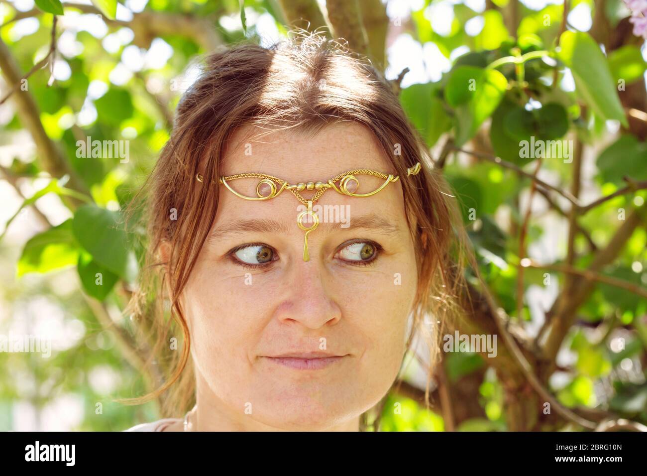 Closeup of young womans head wearing romantic metal tiara on her ...
