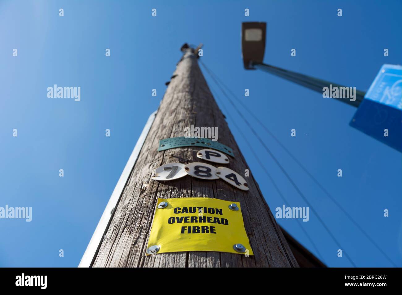 caution overhead fibre label on a telegraph pole in twickenham ...