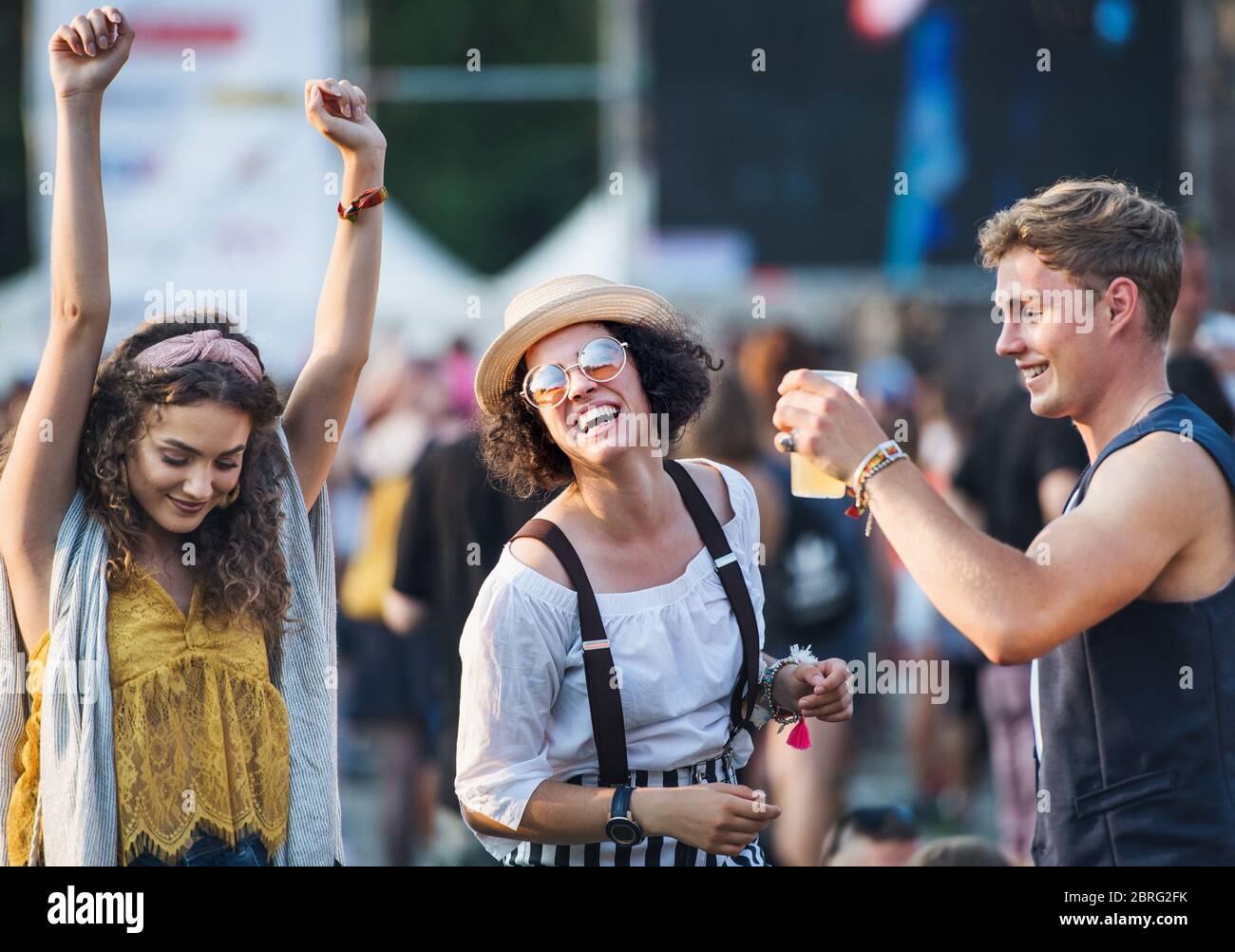 Group of young friends at summer festival, having good time Stock Photo ...