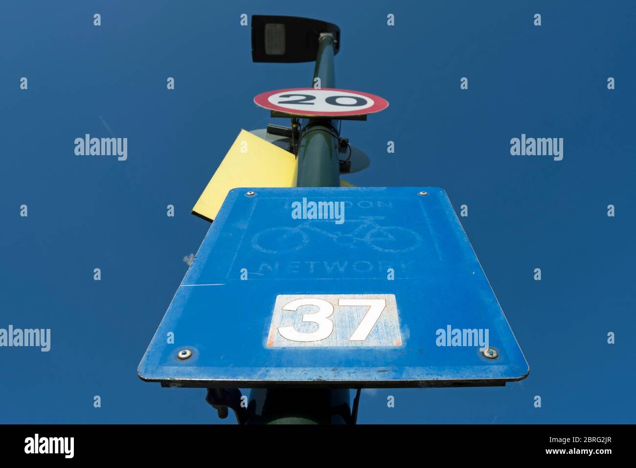 faded london cycle network sign beneath a 20mph speed limit sign ...