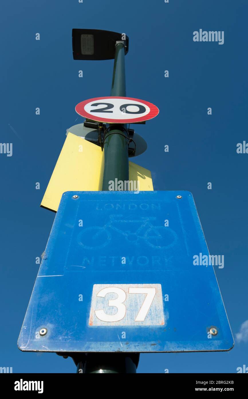 faded london cycle network sign beneath a 20mph speed limit sign ...