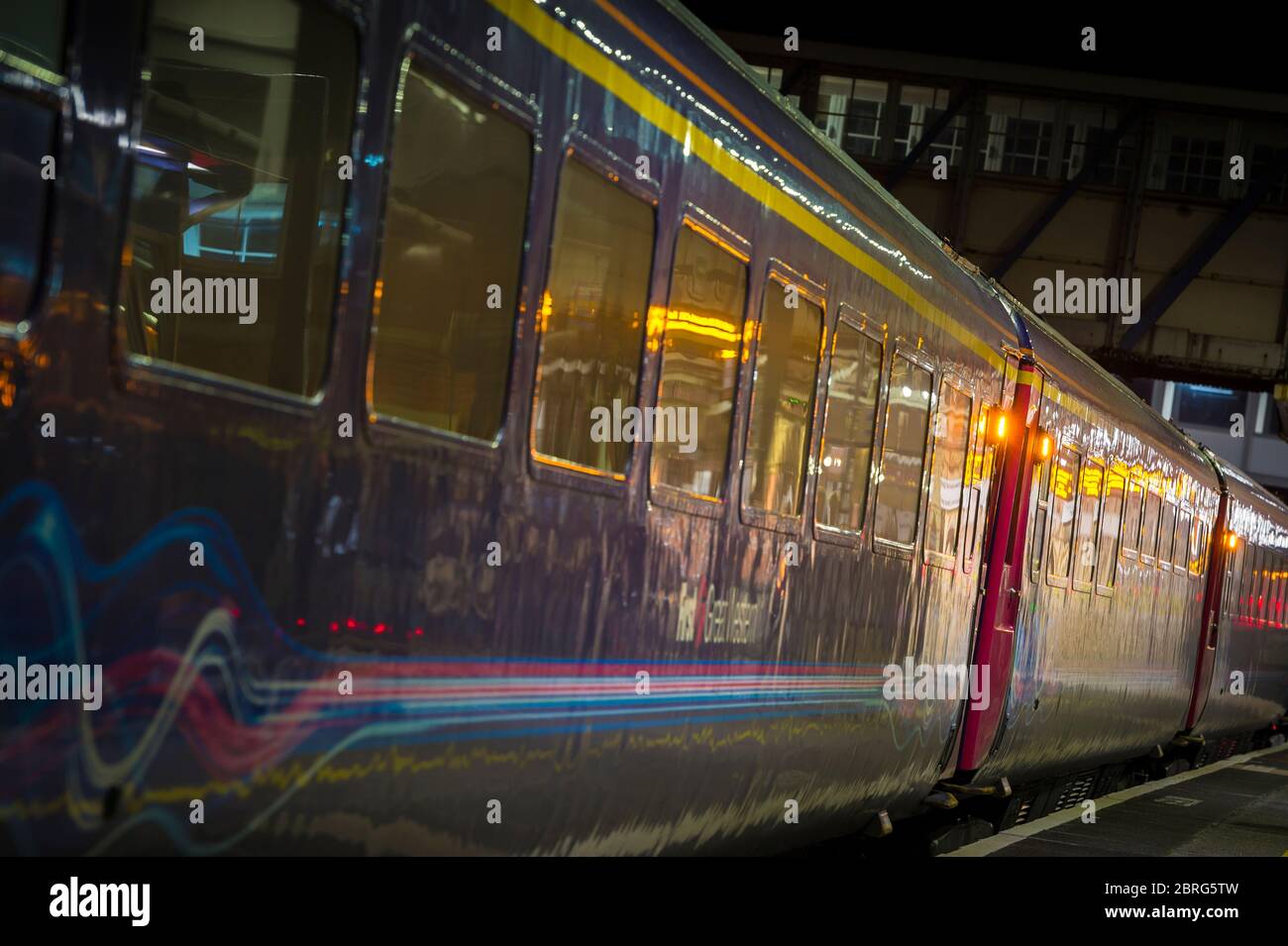 Passenger train in First Great Western livery at a railway station in ...