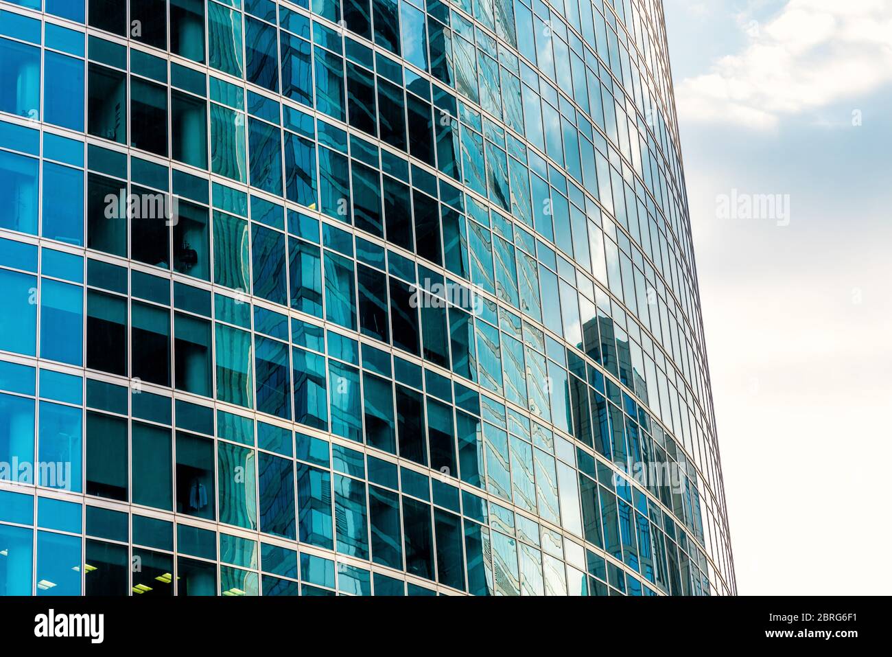 The sky and buildings are reflected in a modern skyscraper. Background ...