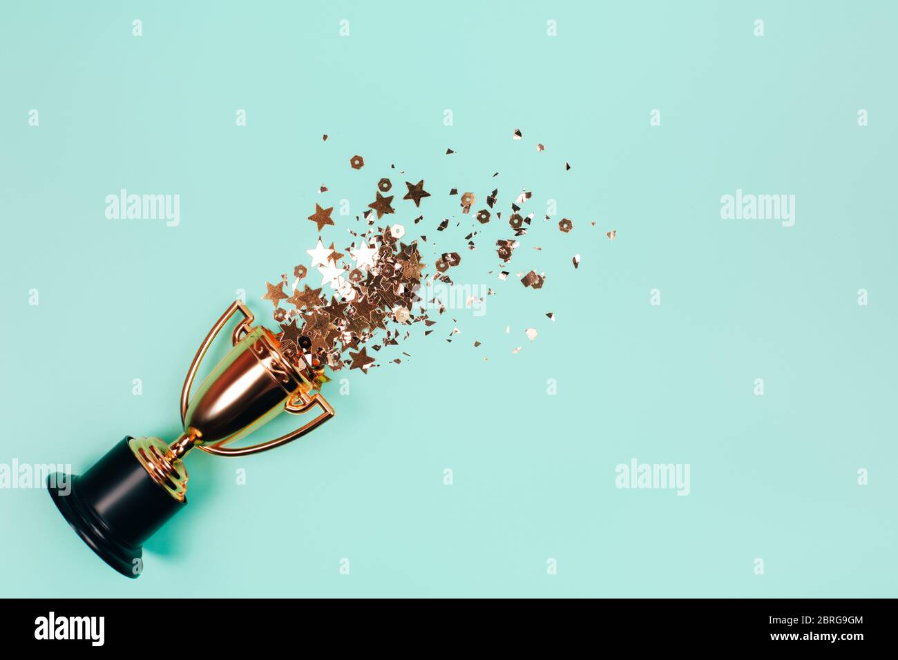 One winners cup with golden sparkles on a pastel background. Banner ...