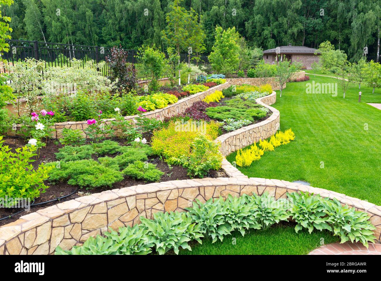 Natural stone landscaping in home garden Stock Photo - Alamy