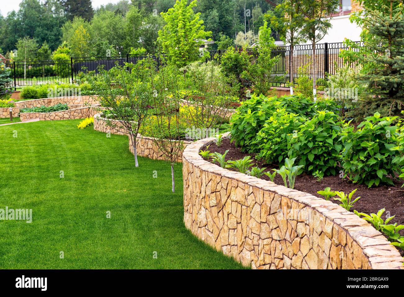Natural stone landscaping in home garden Stock Photo - Alamy