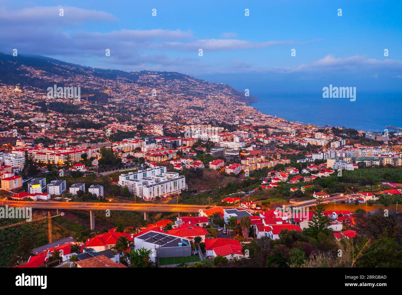Funchal city aerial panoramic view at sunset. Funchal is the capital ...