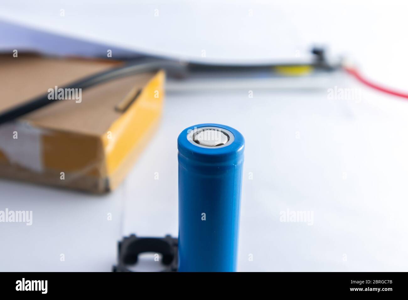 Blue lithium ion battery which placed vertically with blurred ...