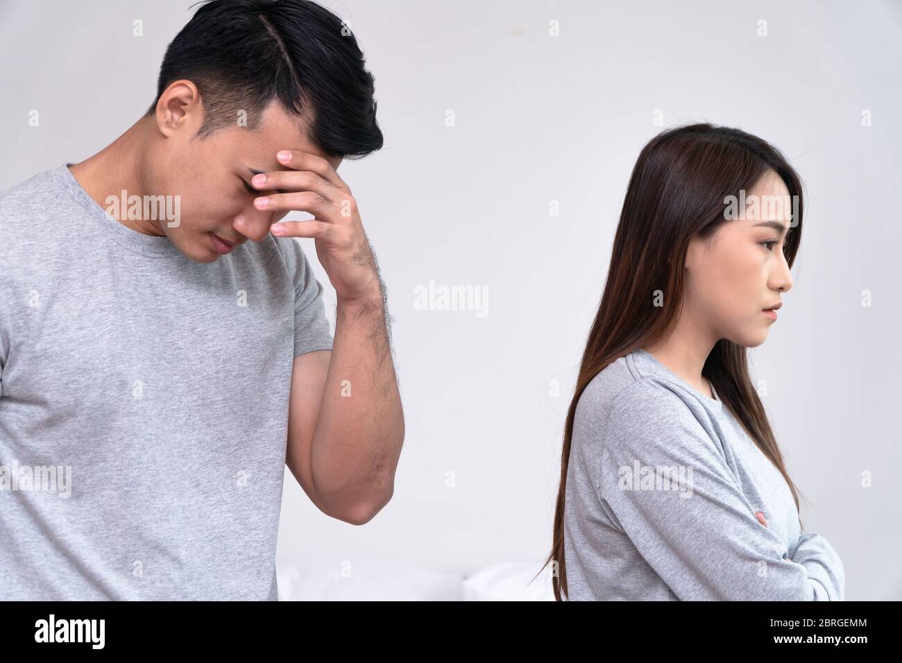 Unhappy Asian Couples Standing Beside Each Other And Women Avoid