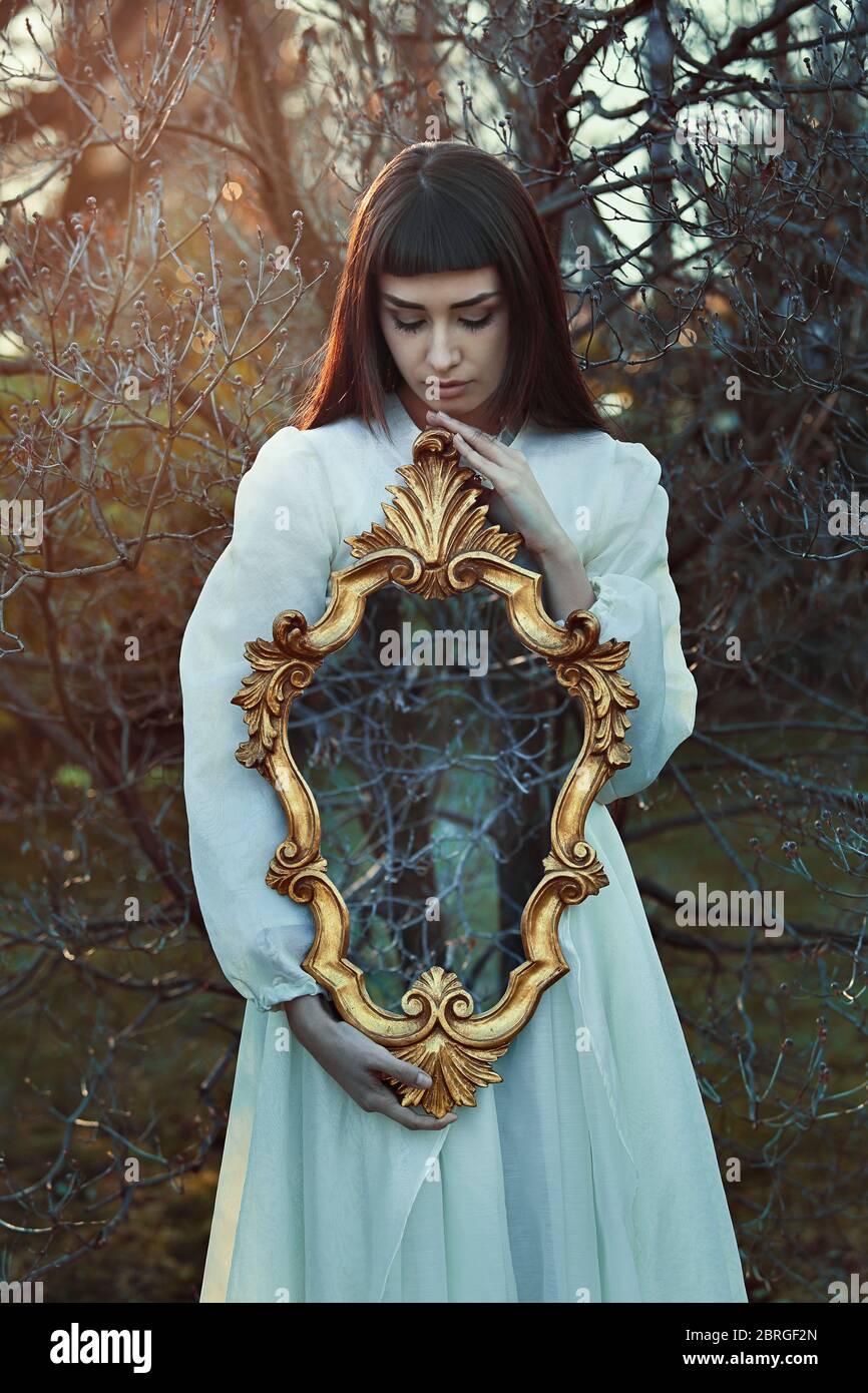 Woman holding strange mirror in sunset light Stock Photo - Alamy