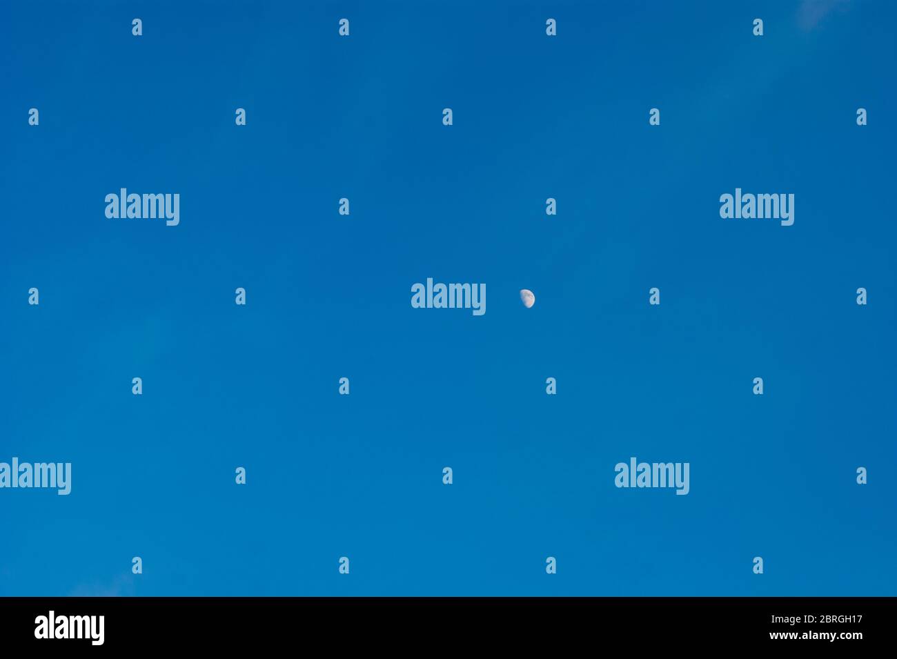 The growing moon or crescent moon is on a canvas of blue clear sky ...