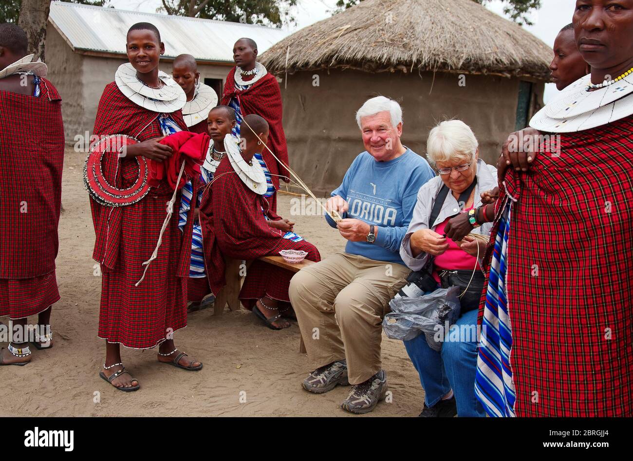 visitors weaving, man, woman, tourists, Maasai women, tribal dress, red ...