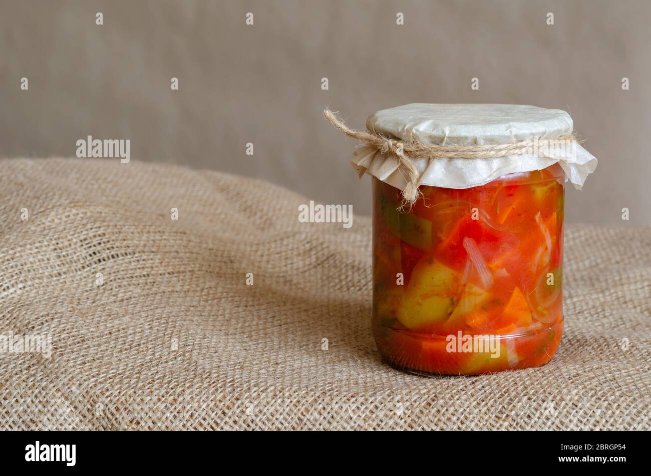 Glass can with lecho, home canned food on burlap. canning and storage ...