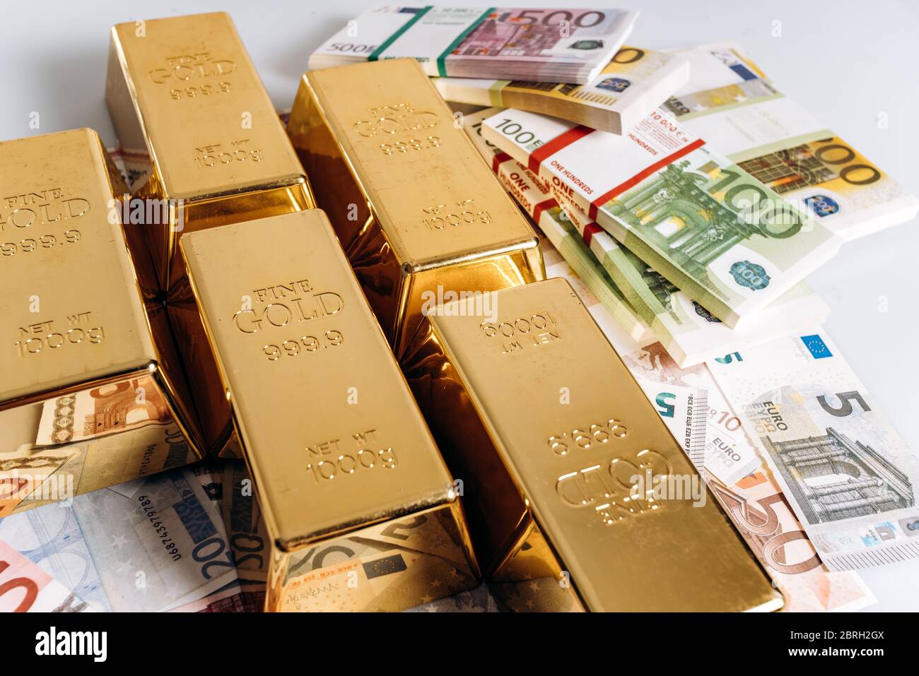 Gold bullions at euro banknotes closeup background. Gold bars lie on ...