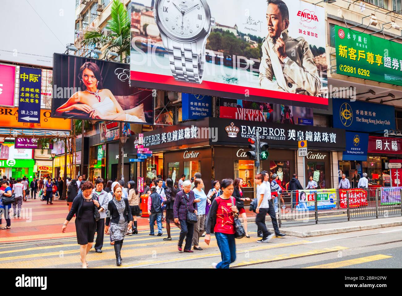 HONG KONG - MARCH 19, 2013: Pedestrians rush crossing through a very ...