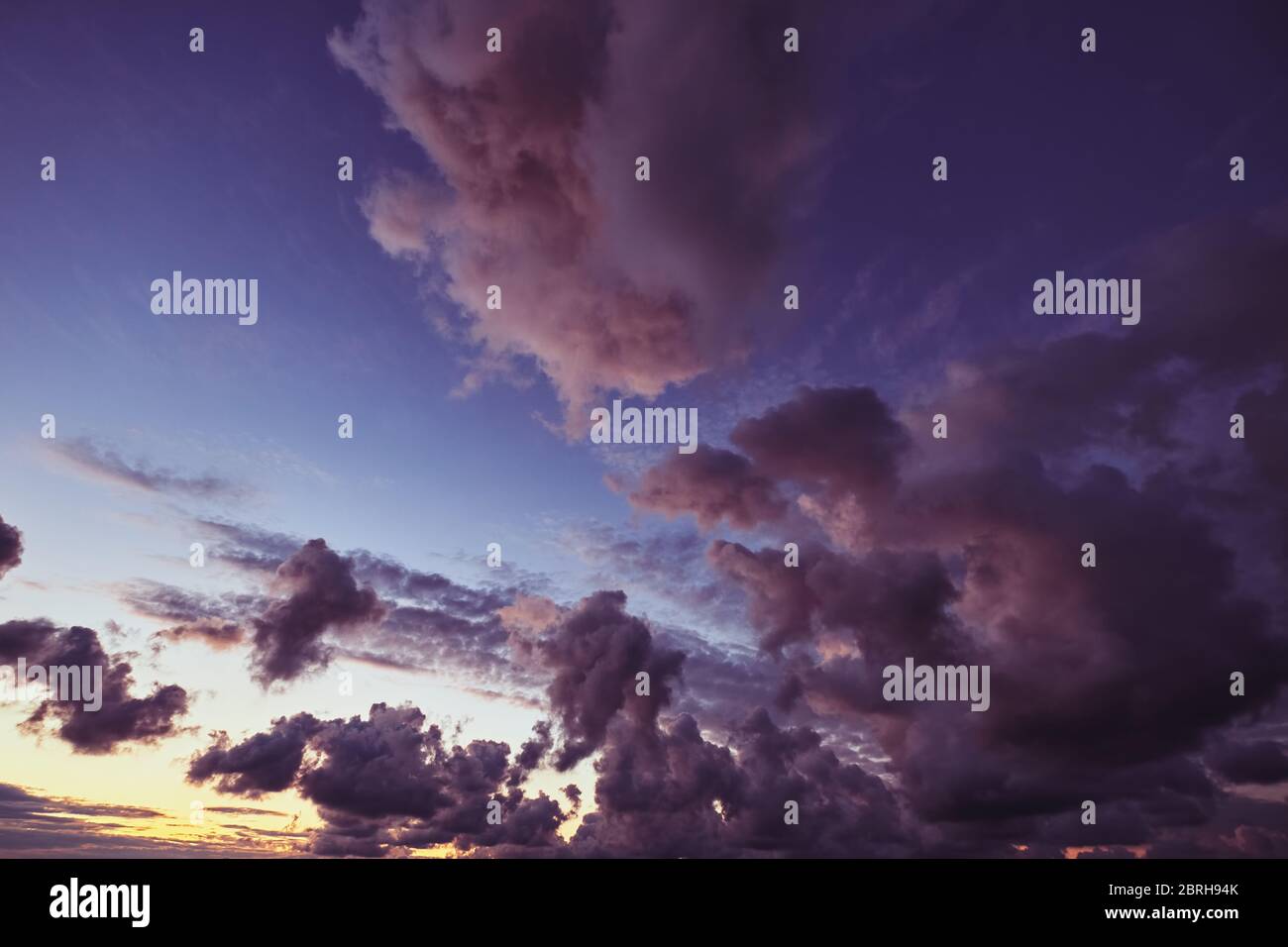 Dramatic purple clouds during sunset after a thunderstorm Stock Photo ...