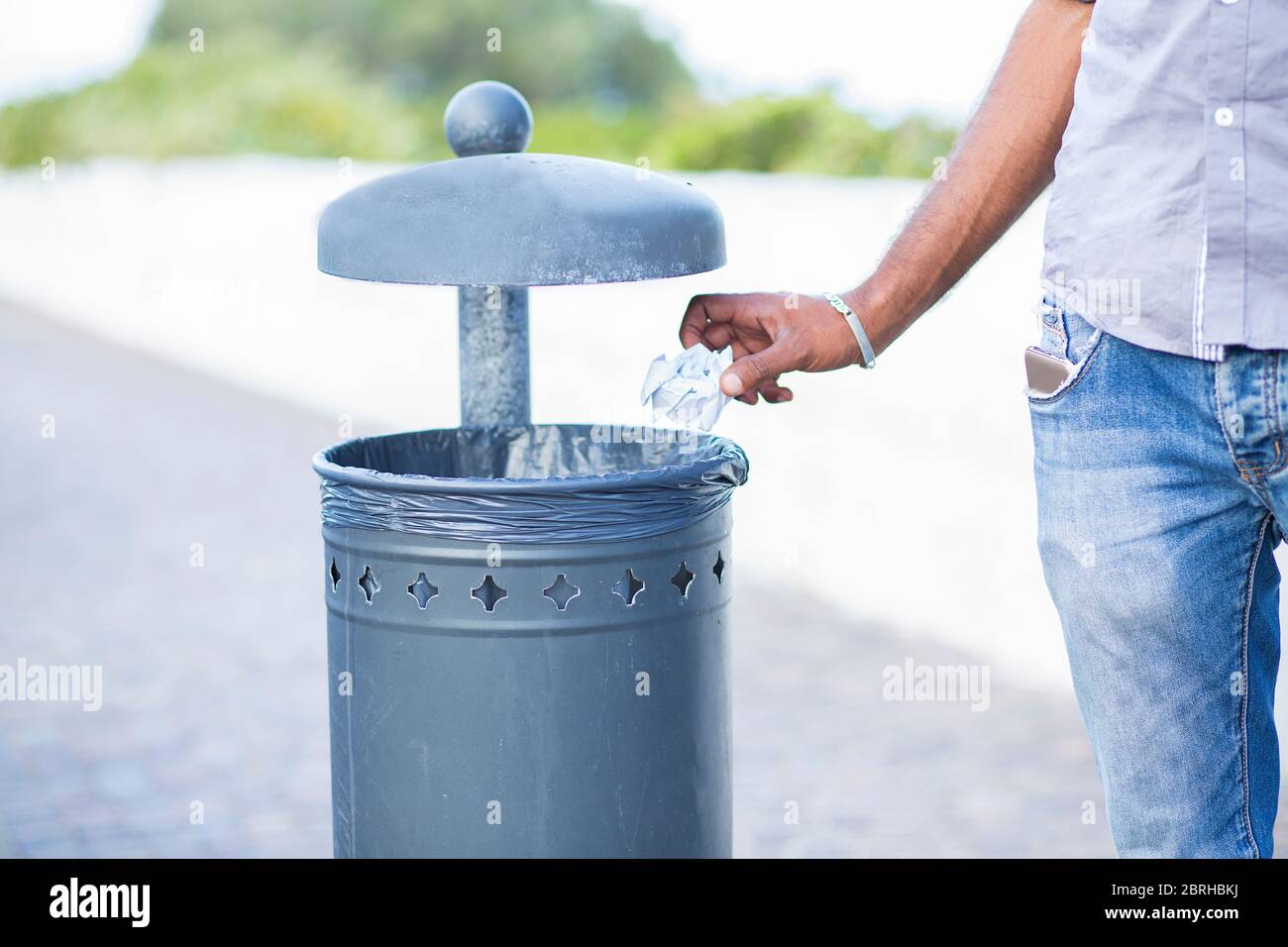 Man, unrecognisable person throwing trash in recycling bin, isolated ...