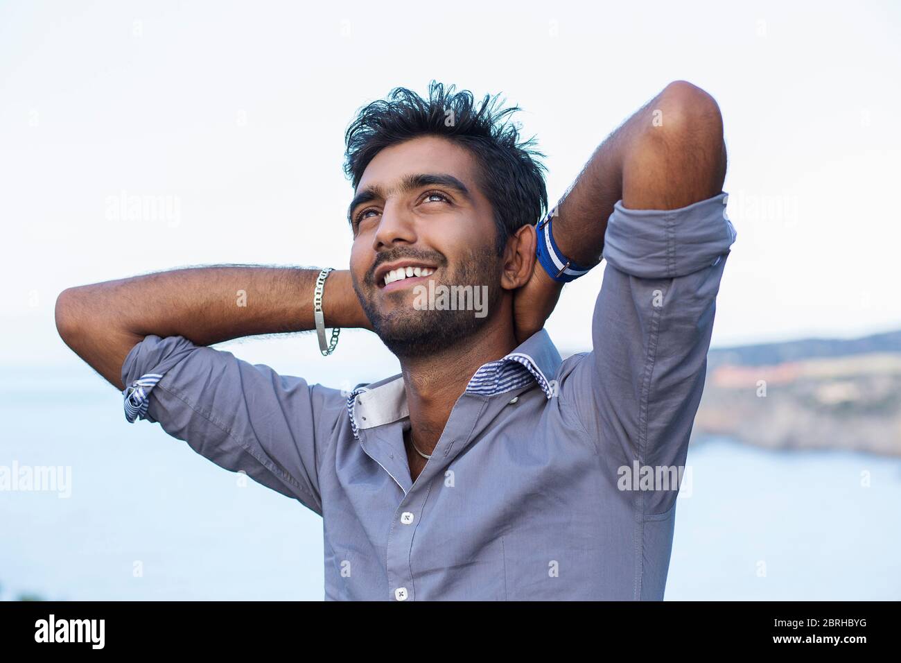 Man smiling looking up to blue sky taking deep breath celebrating ...