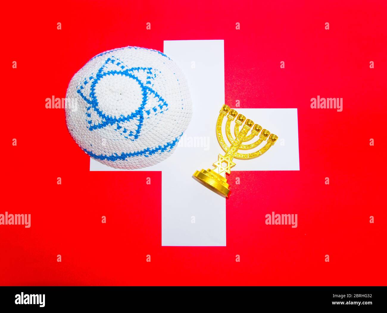 Aerial photo of a Swiss flag with a jewish yarmulke and a chandelier ...