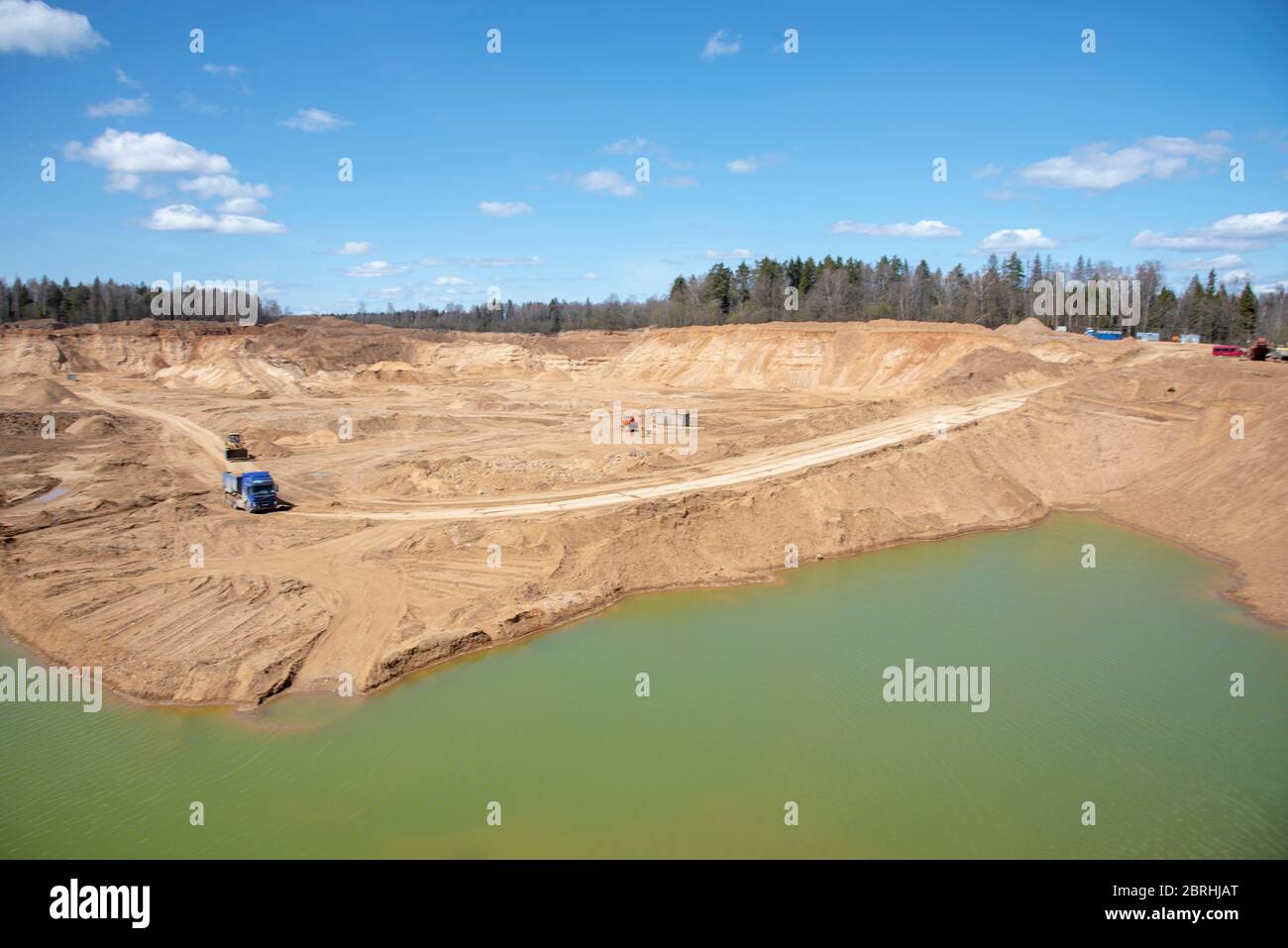Sand deep quarry under a blue cloudy sky Stock Photo - Alamy